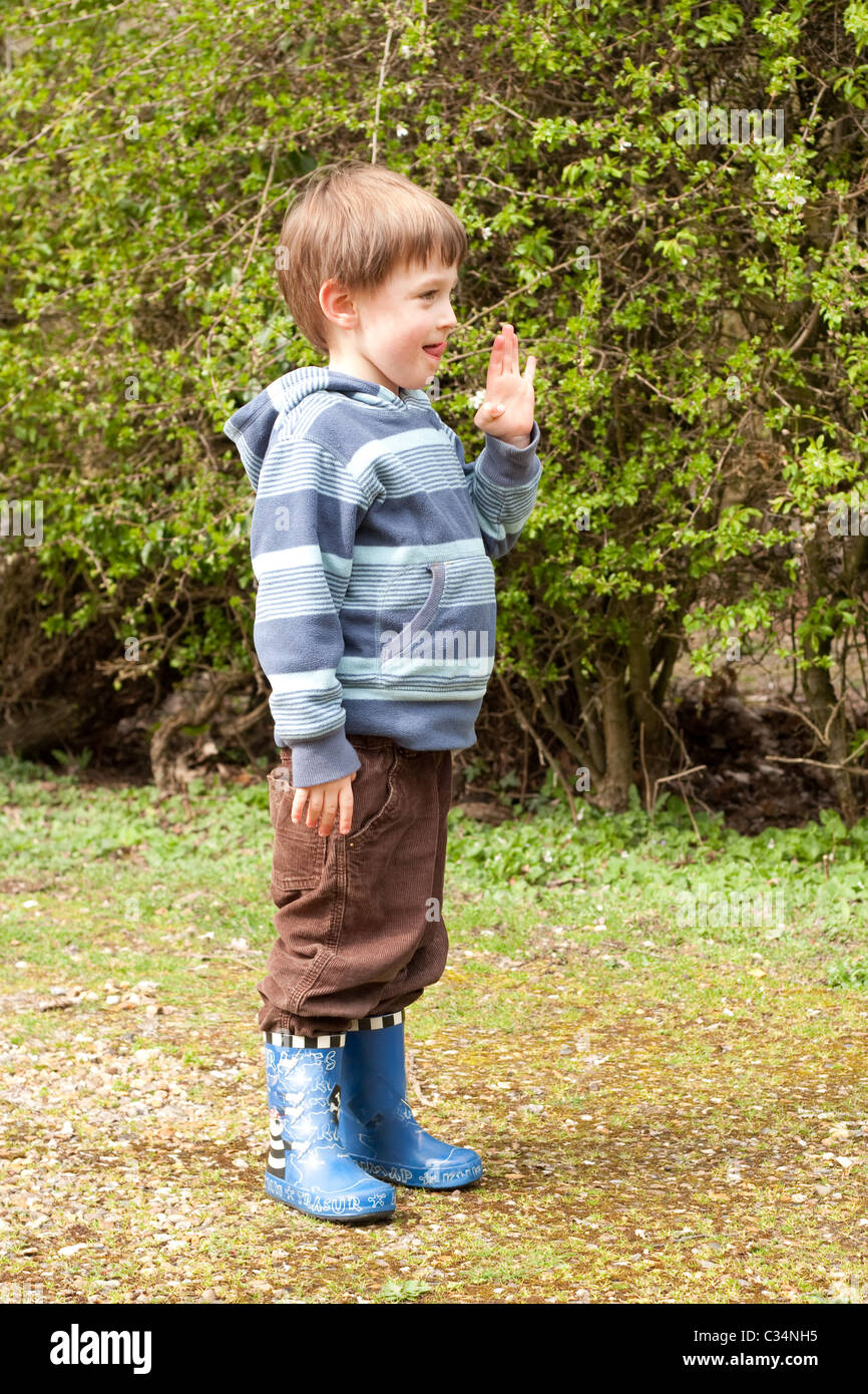Little boy waving or indicating to stop Stock Photo - Alamy