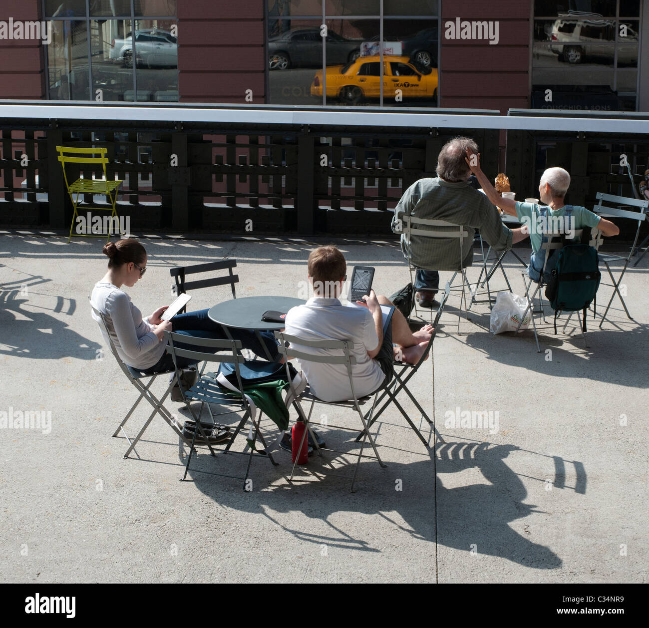 Reader use their Amazon Kindle ereaders in the High Line Park in New ...