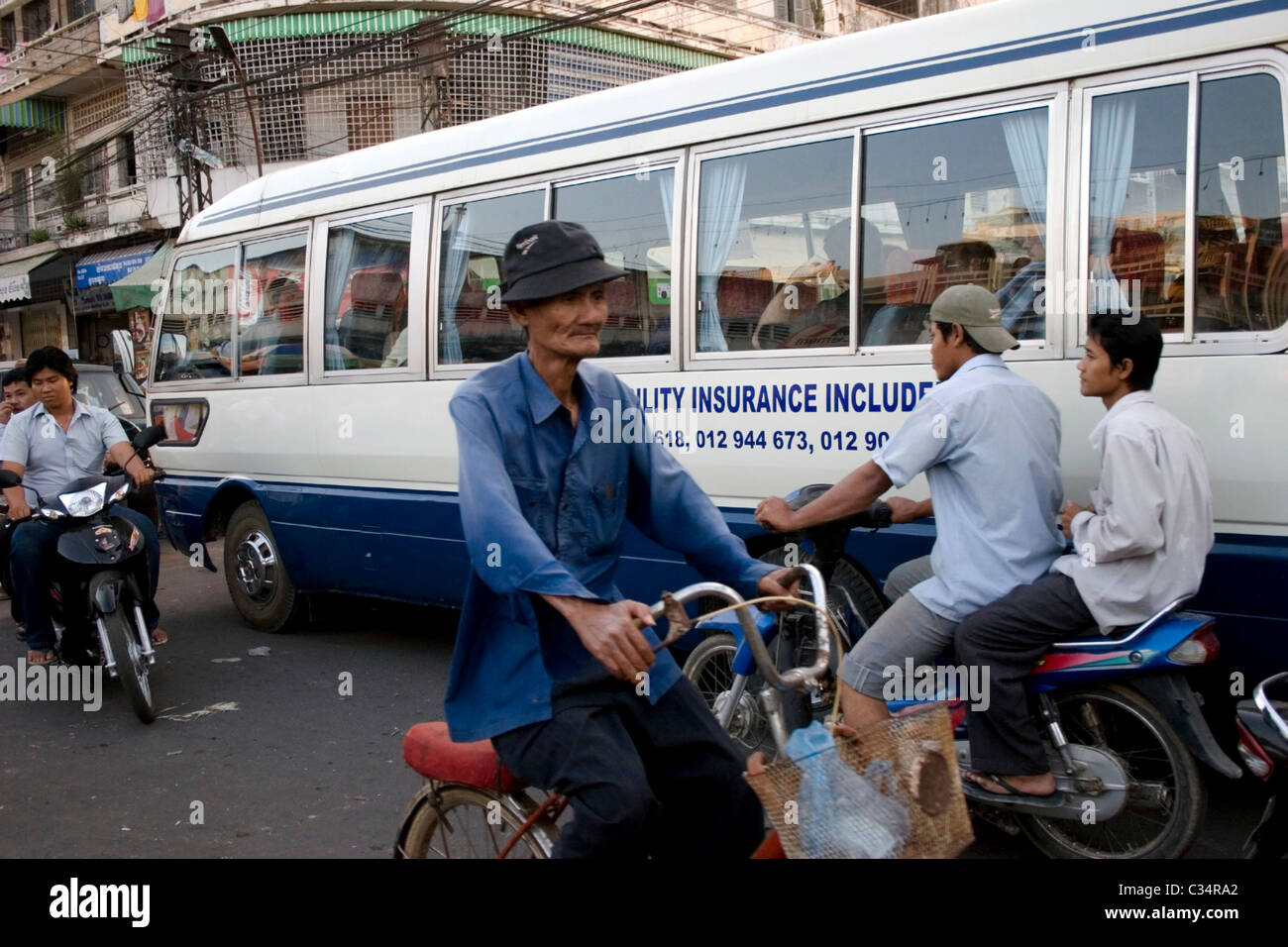 Foreign tourists are riding in a tour bus on a street crowded with ...