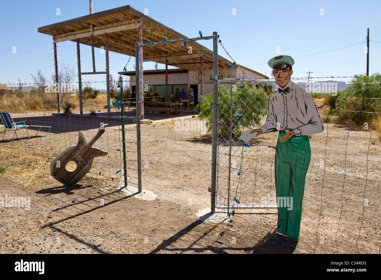 Cut out of a gas station attendant in front of an abandoned station in ...