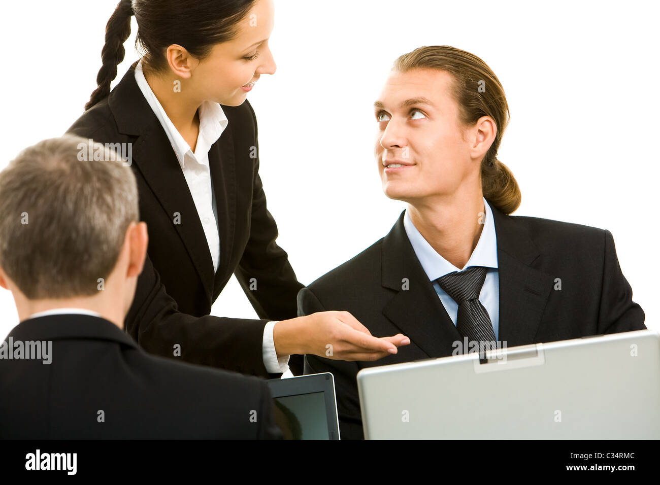 Portrait of executive employees looking at each other and communicating ...