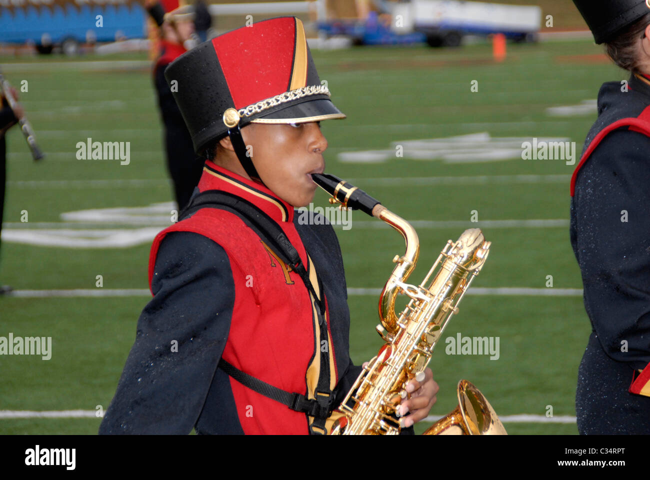 teen playing in the marching band during halftime show during a high ...