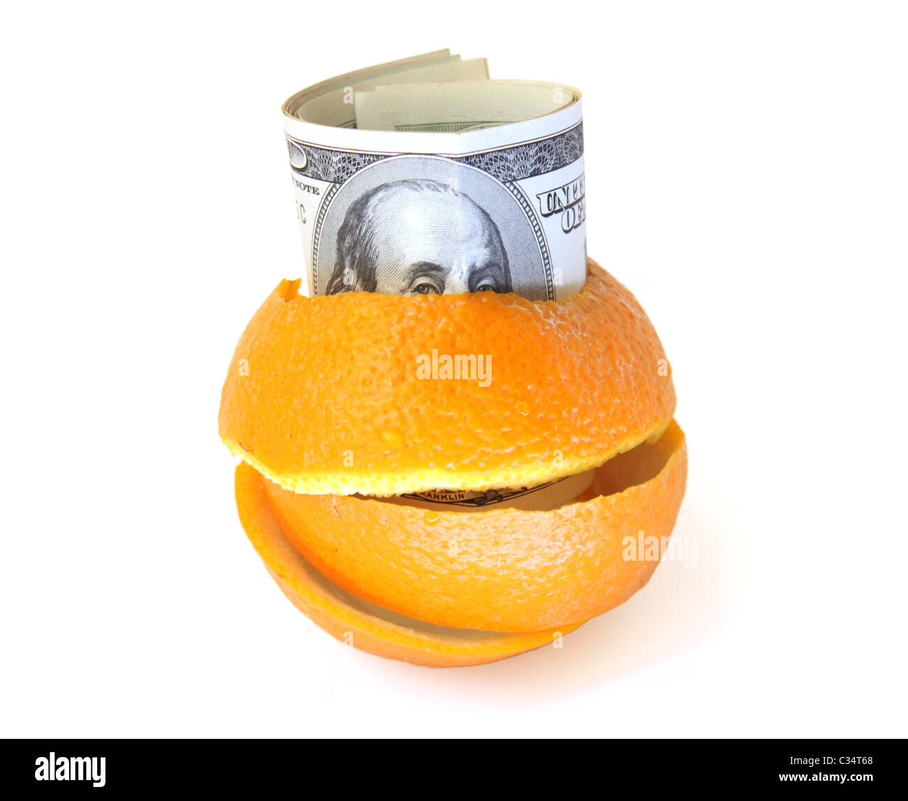 roll of dollars inside orange peel Stock Photo - Alamy