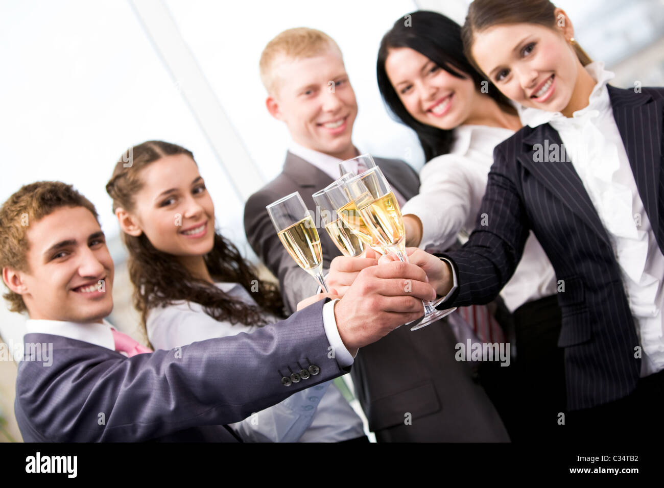 Image of friends making cheers and looking at camera Stock Photo - Alamy