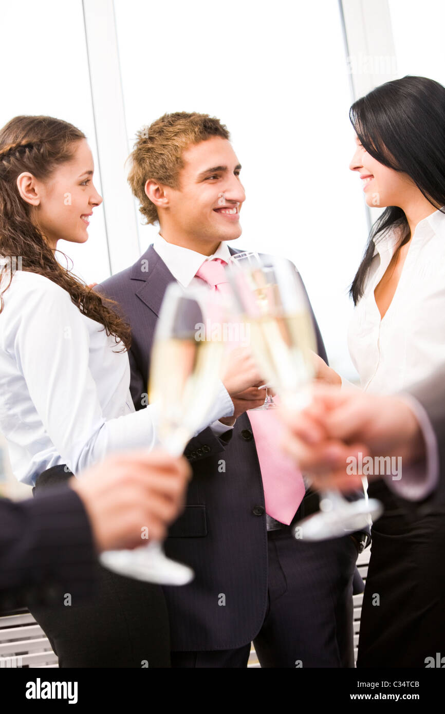 Image of cheering friends interacting at corporate party Stock Photo ...
