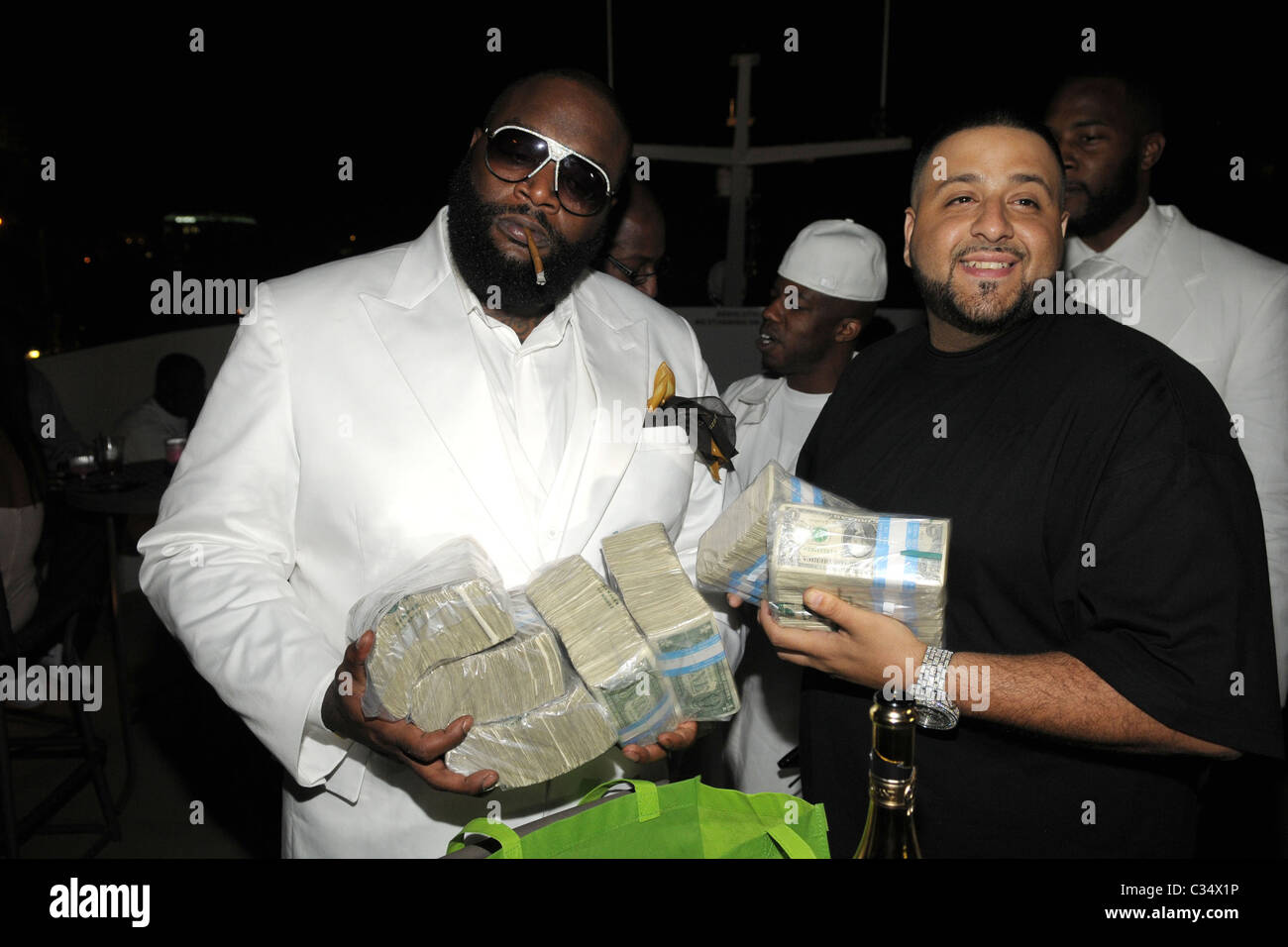 Rick Ross and DJ Khaled hold a stacks of one dollar bills Rick Ross ...