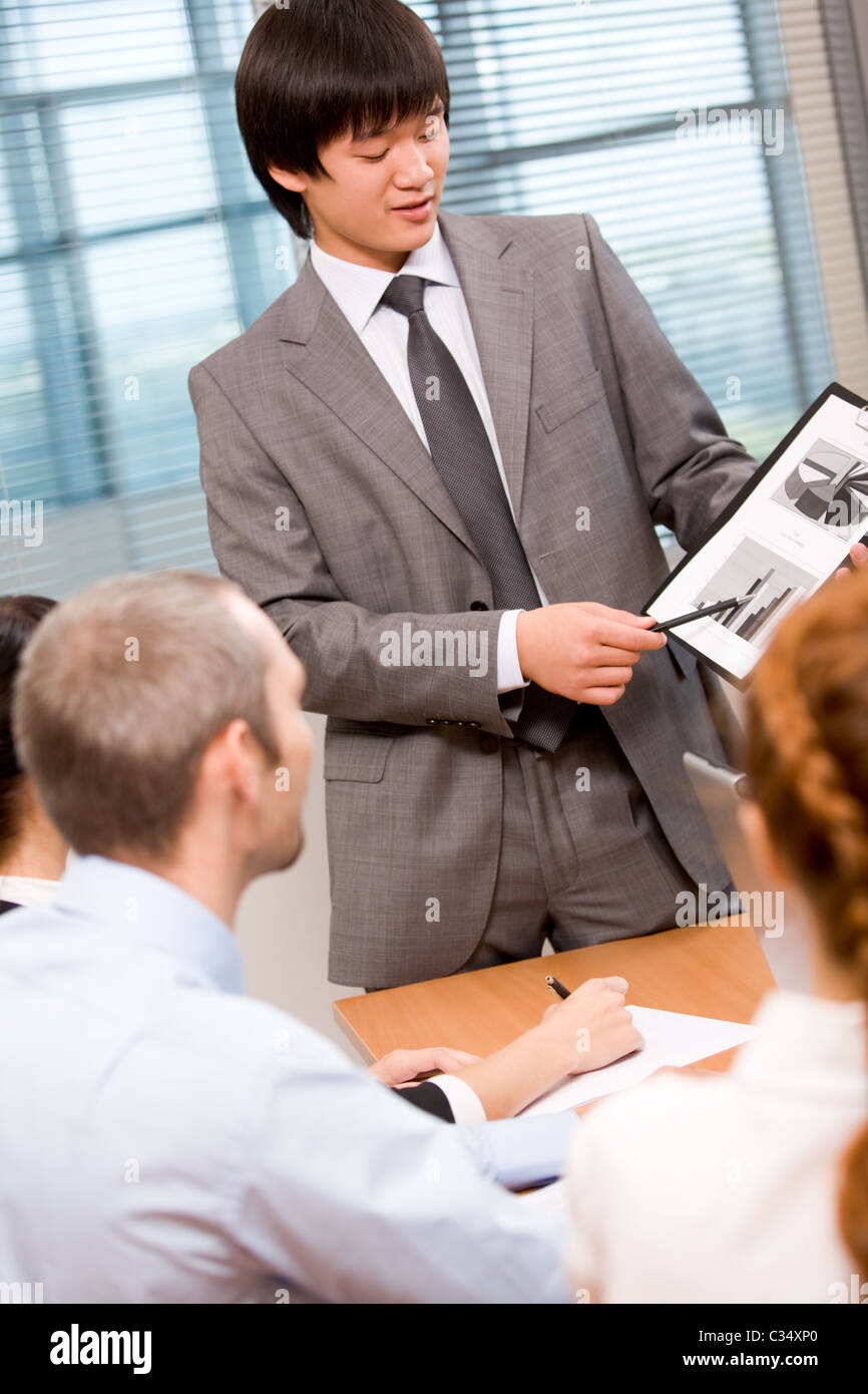 Photo of confident leader pointing at paper with diagrams during ...