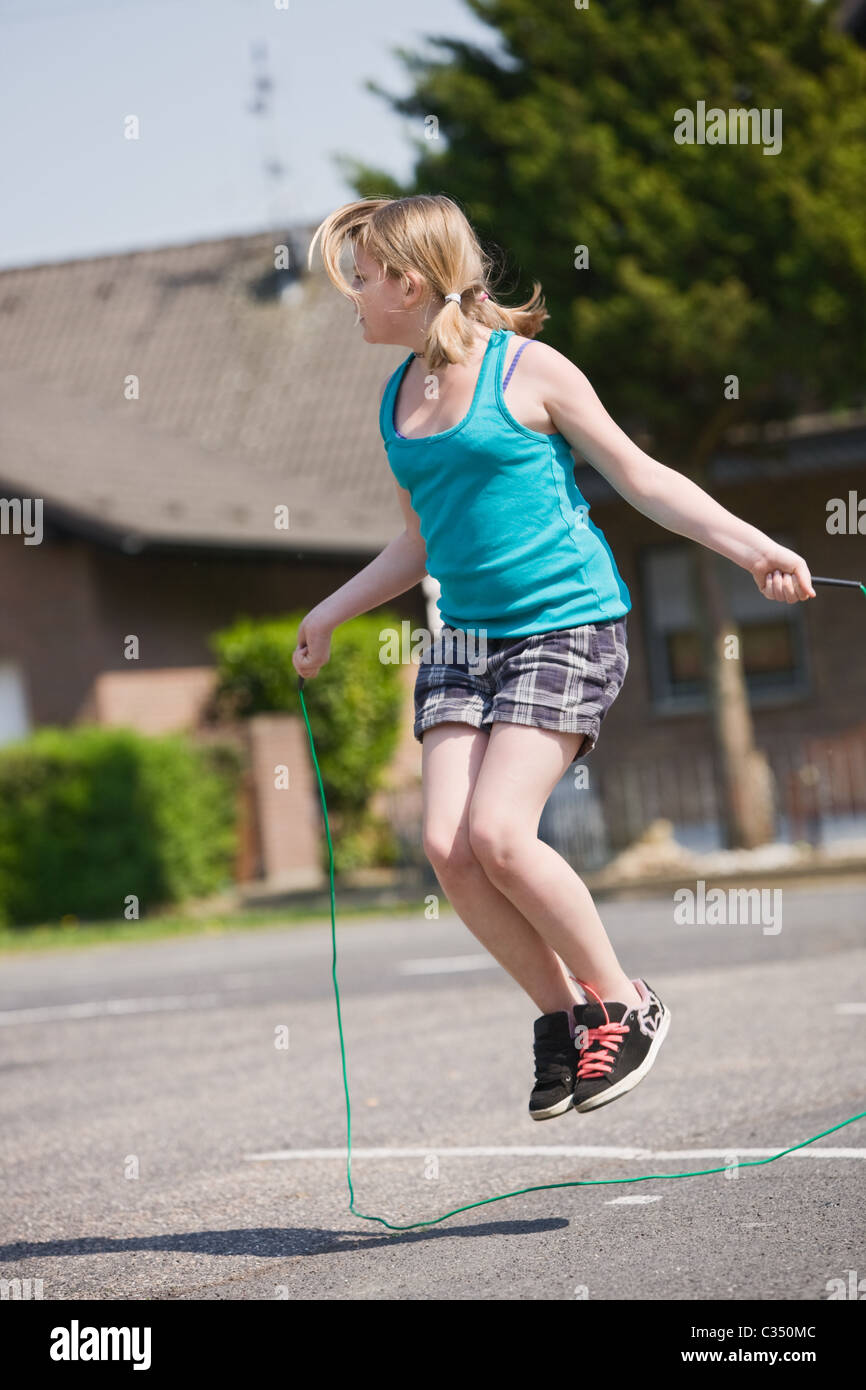 Young girl jumping rope outdoors Stock Photo - Alamy
