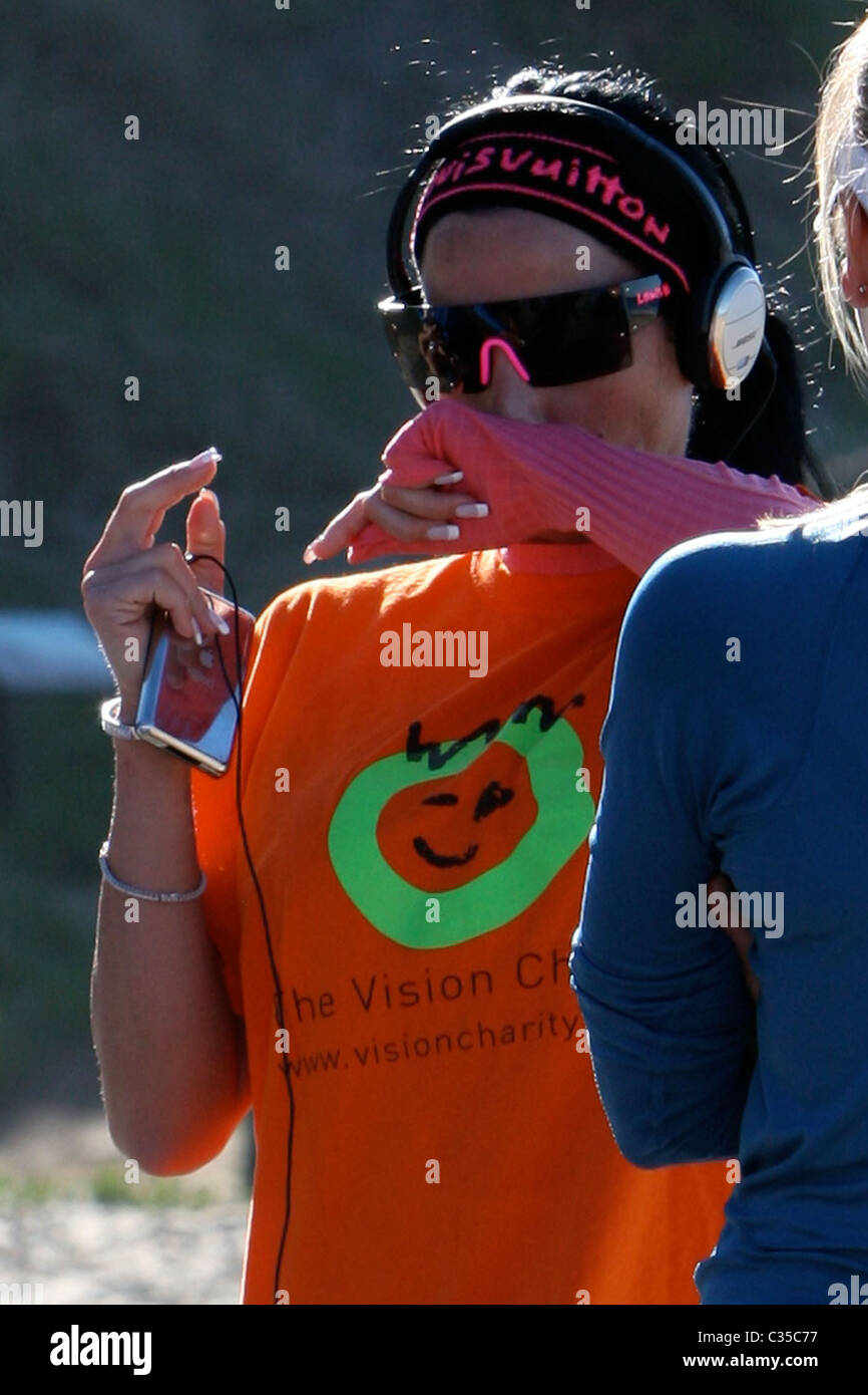Katie Price seen warming up before jogging at the beach with friends ...