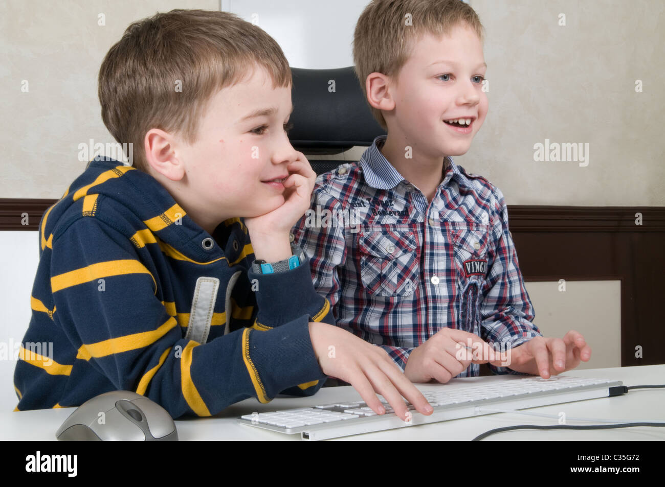 Two friends are having fun while working on a computer Stock Photo - Alamy