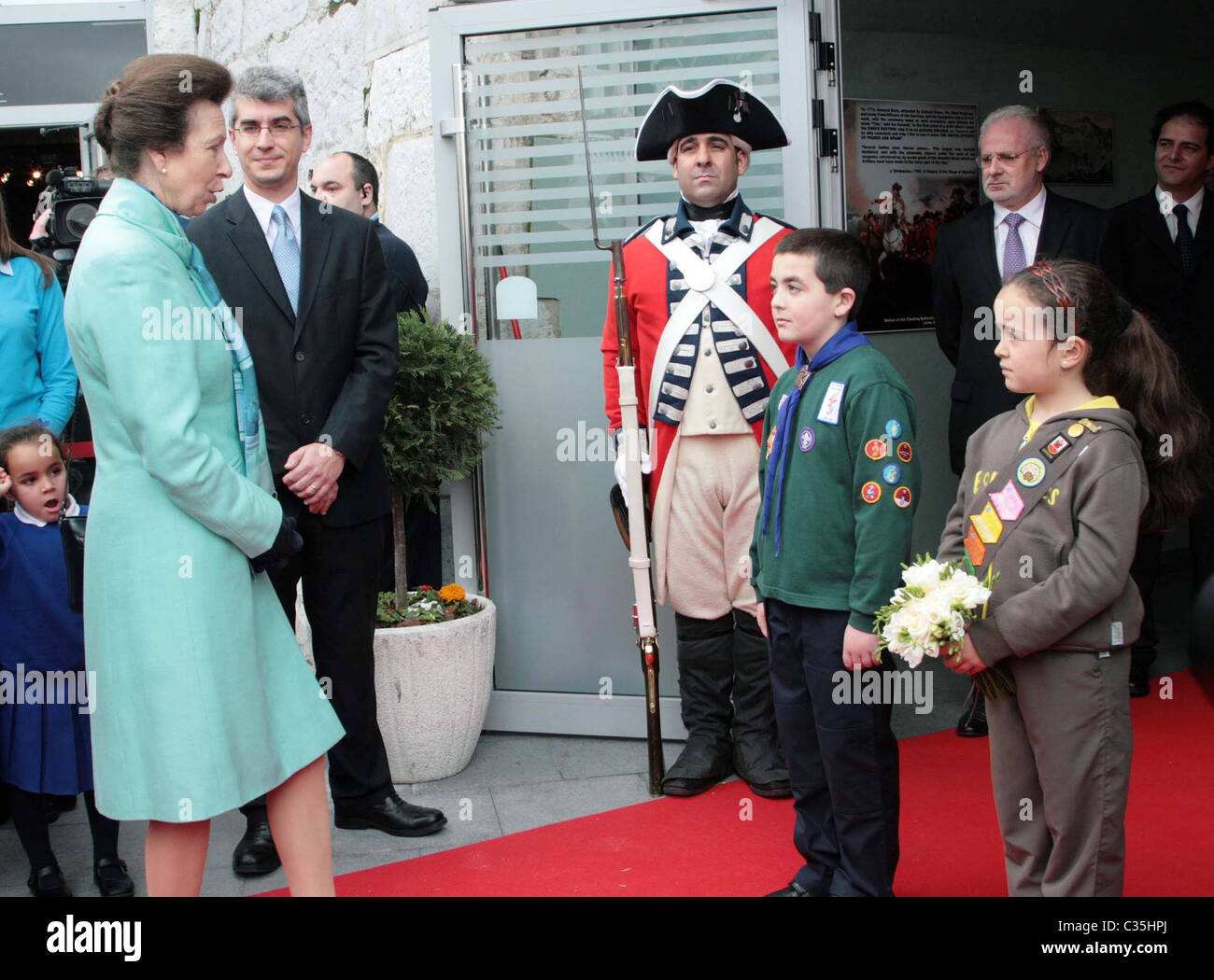 Britain's Princess Anne receives flowers from children during her visit ...