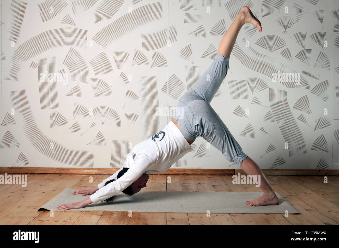 Woman during yoga exercise at a yoga body posture Stock Photo - Alamy