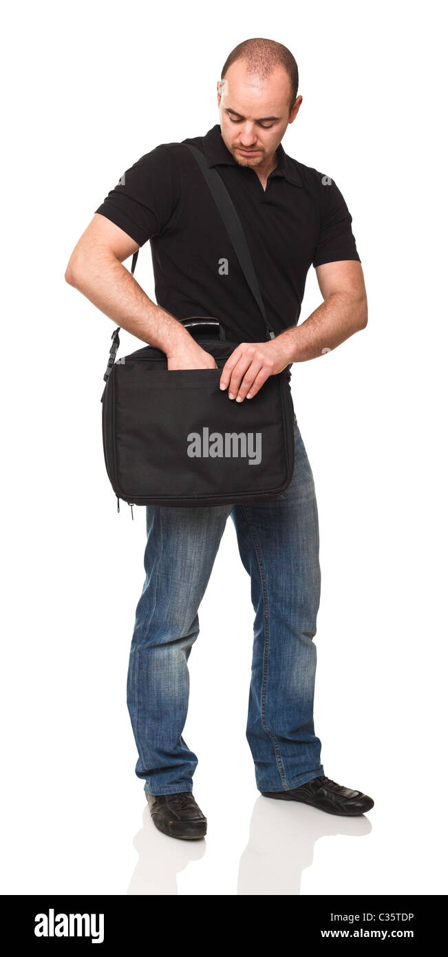 standing caucasian man looking in his bag Stock Photo - Alamy