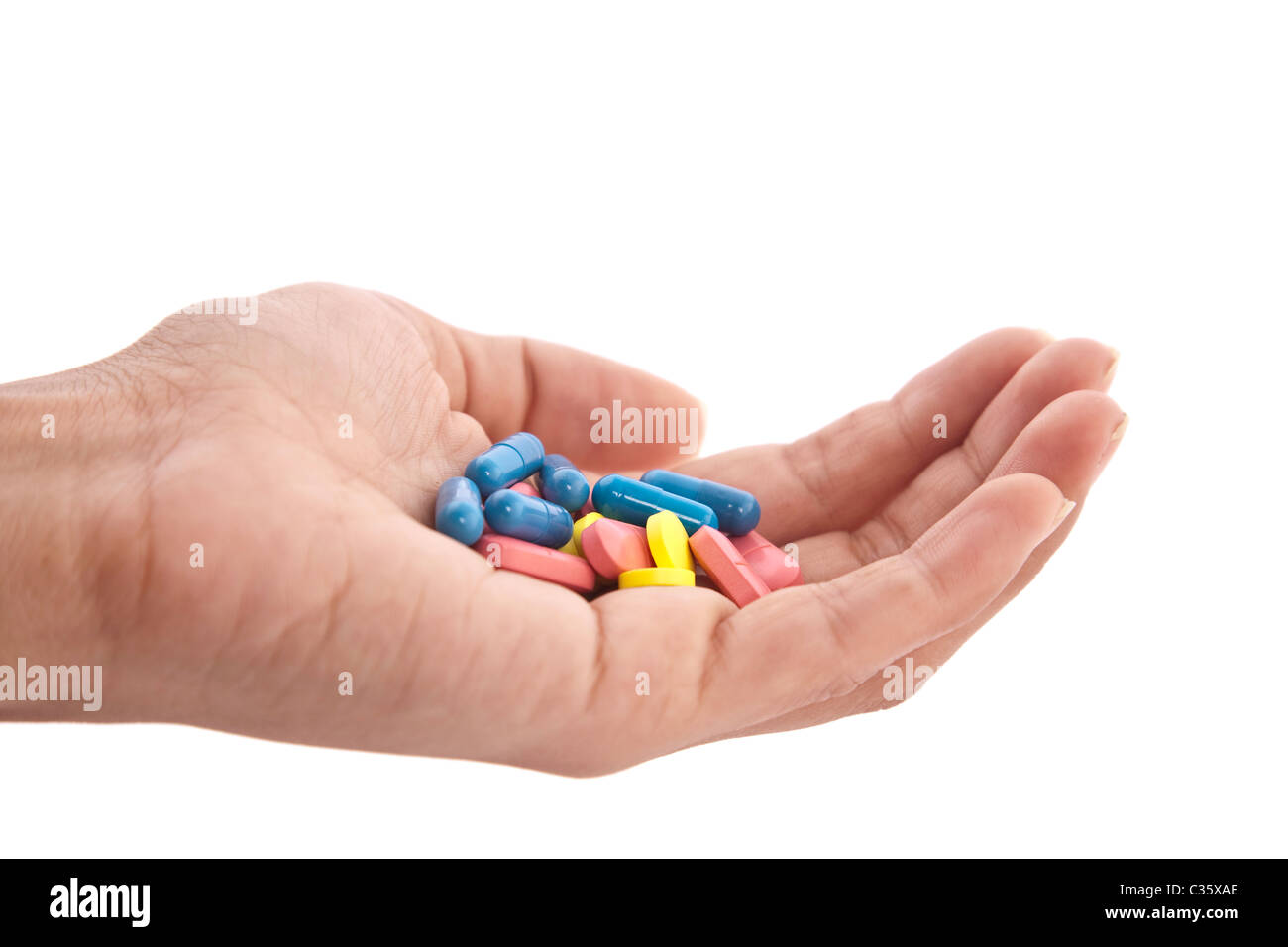 pills in hand isolated on white background Stock Photo - Alamy