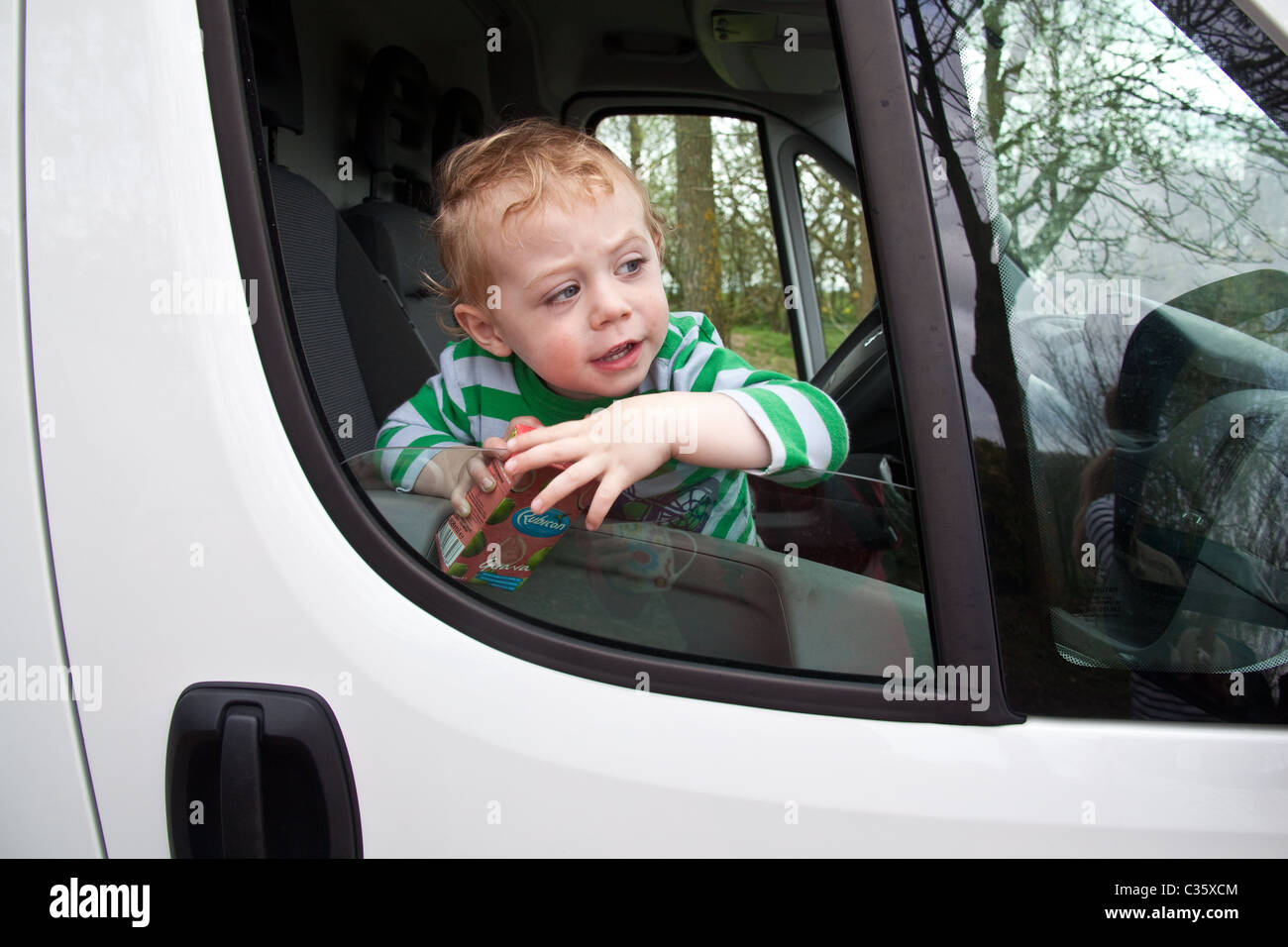 Two year old boy in the drivers seat of a transit van. Hampshire ...