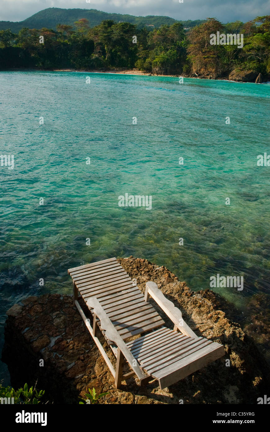 Wooden lounge chair at the beach cove at Great Huts eco-resort, Boston ...