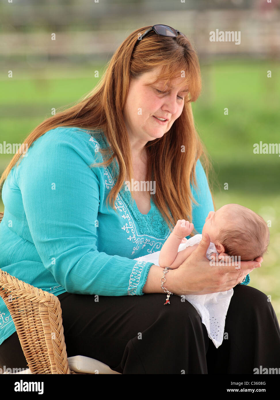 54 year old grandmother hold her six week old newborn female grandchild ...