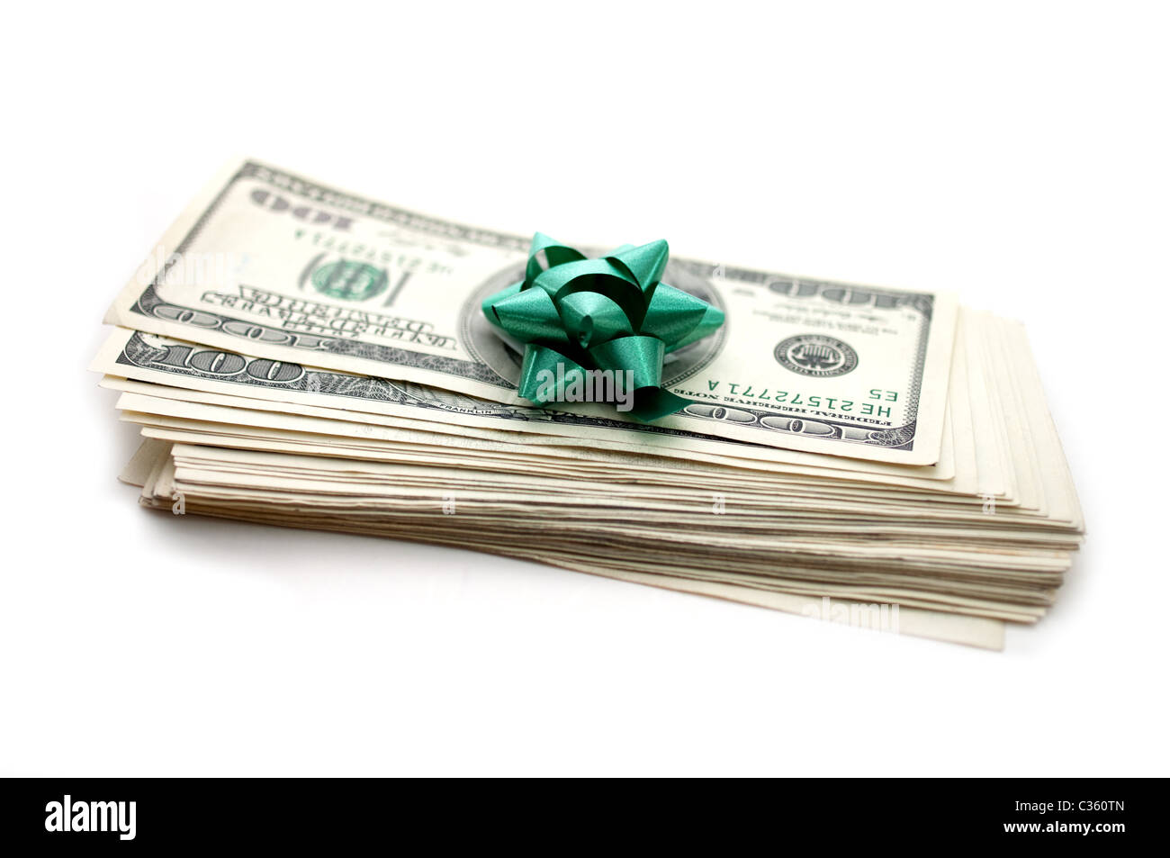 Stack of dollar bills with green gift bow isolated on white background ...
