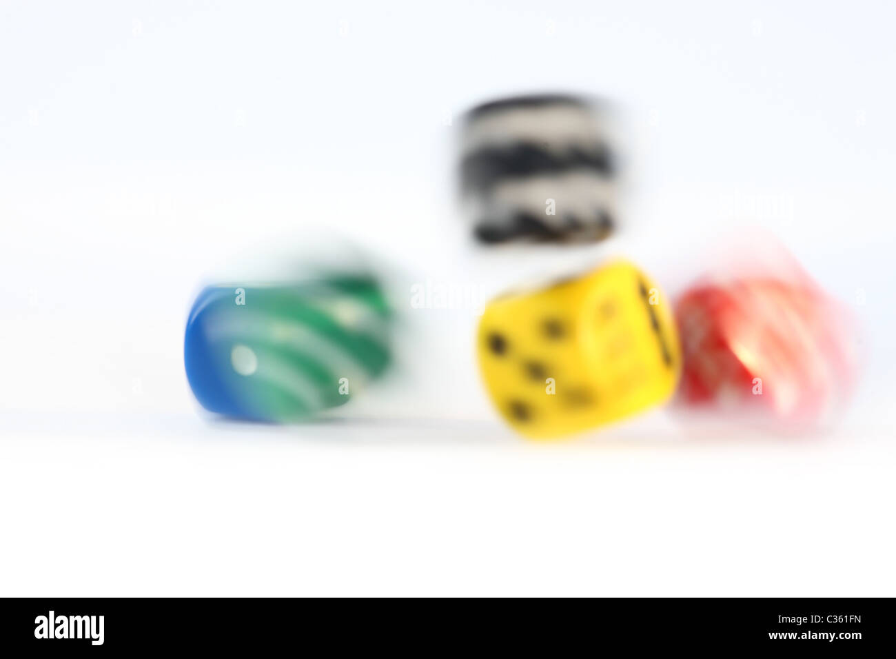 Multi colored dice rolling Stock Photo - Alamy