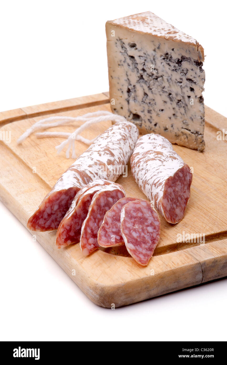 Rustic still life with cutting board, smoked sausage, and matured blue ...