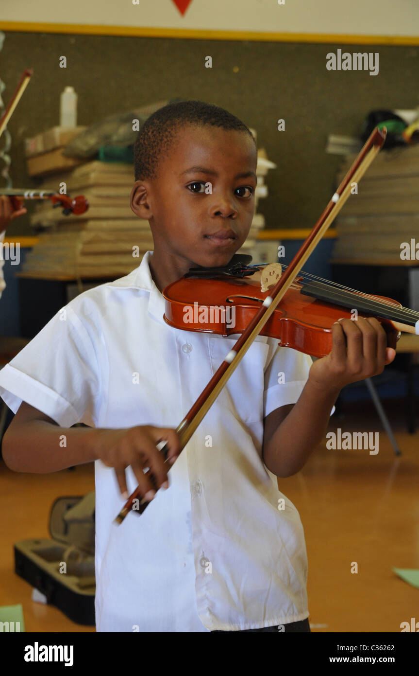 Kids are learning to play the violin in one of the townships around ...
