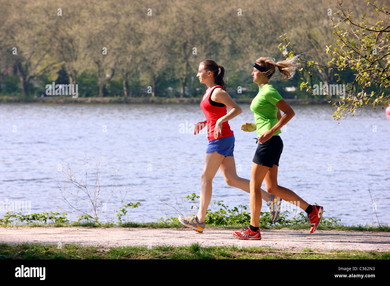 Two female hobby runners. Jogging in nature, in summer Stock Photo - Alamy