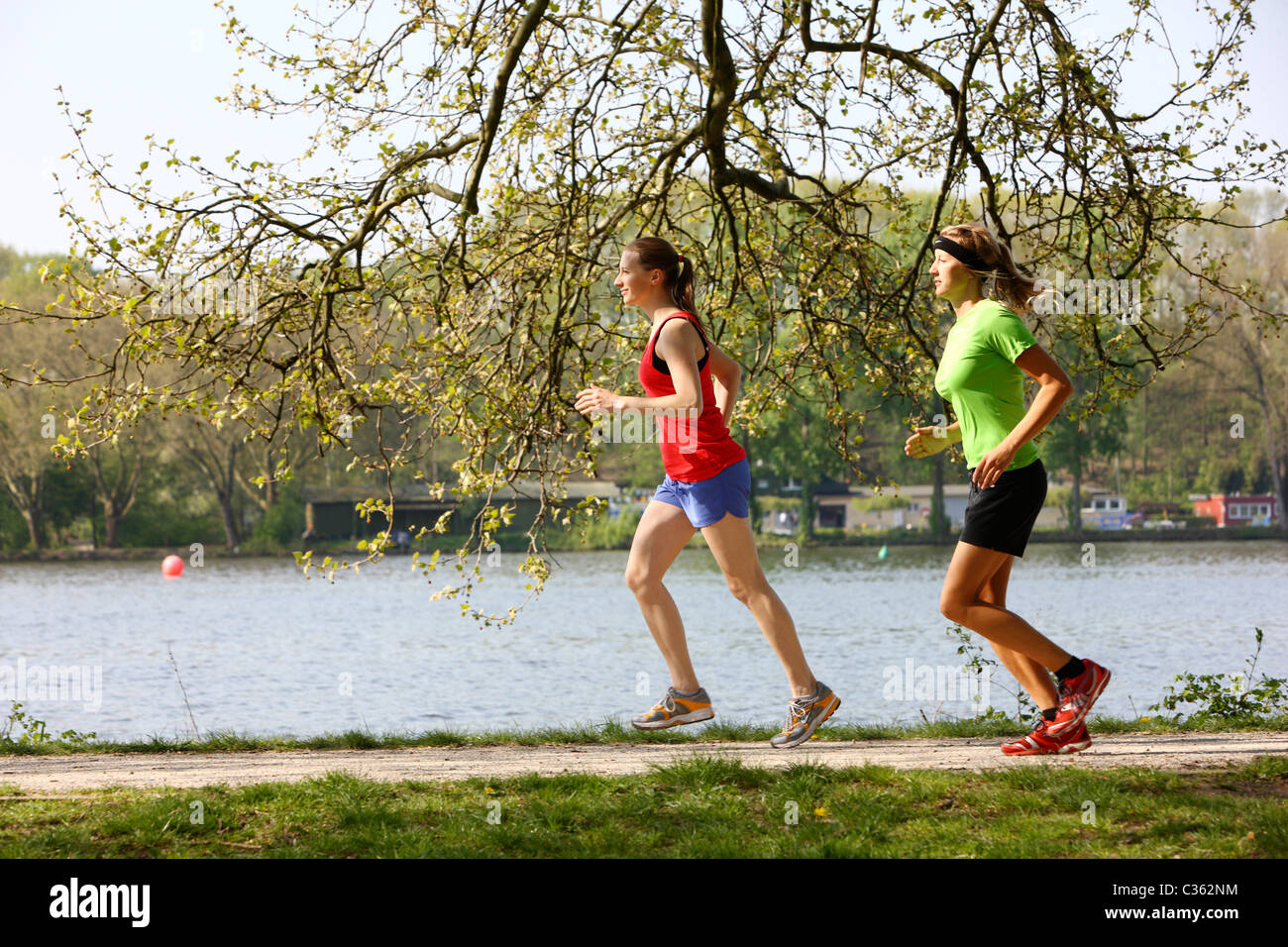 Two female hobby runners. Jogging in nature, in summer Stock Photo - Alamy