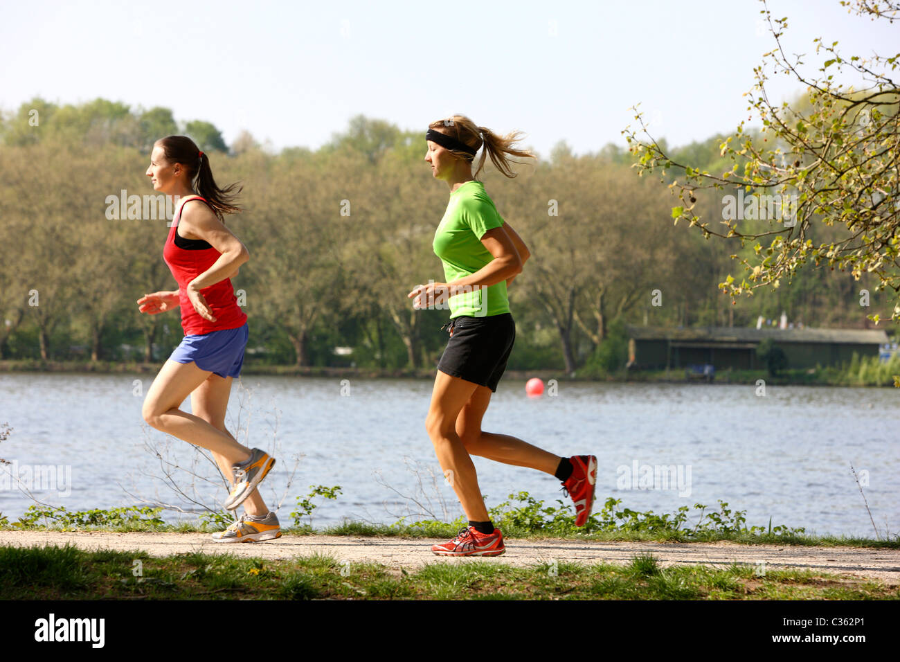 Two female hobby runners. Jogging in nature, in summer Stock Photo - Alamy