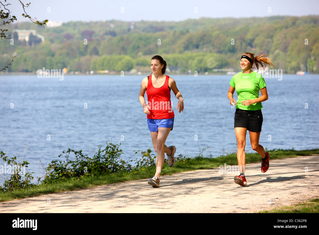 Two female hobby runners. Jogging in nature, in summer Stock Photo - Alamy
