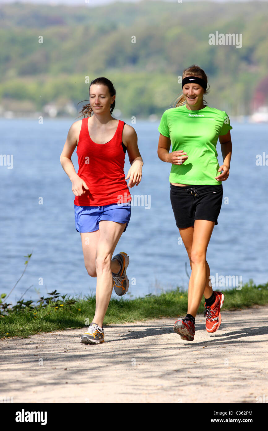 Two female hobby runners. Jogging in nature, in summer Stock Photo - Alamy