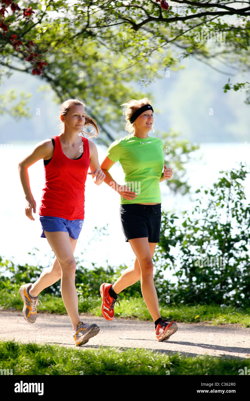 Two female hobby runners. Jogging in nature, in summer Stock Photo - Alamy