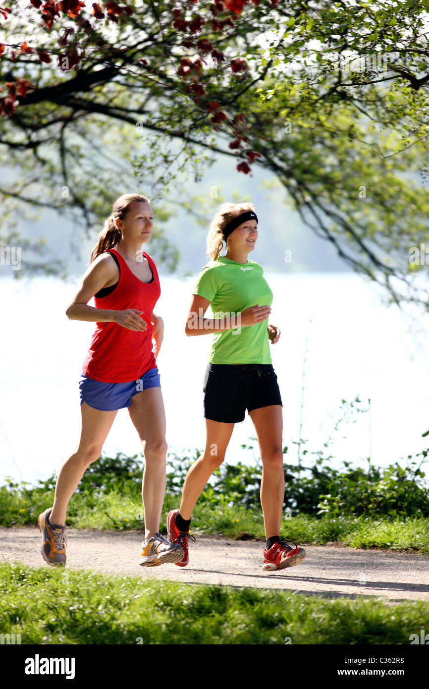 Two female hobby runners. Jogging in nature, in summer Stock Photo - Alamy