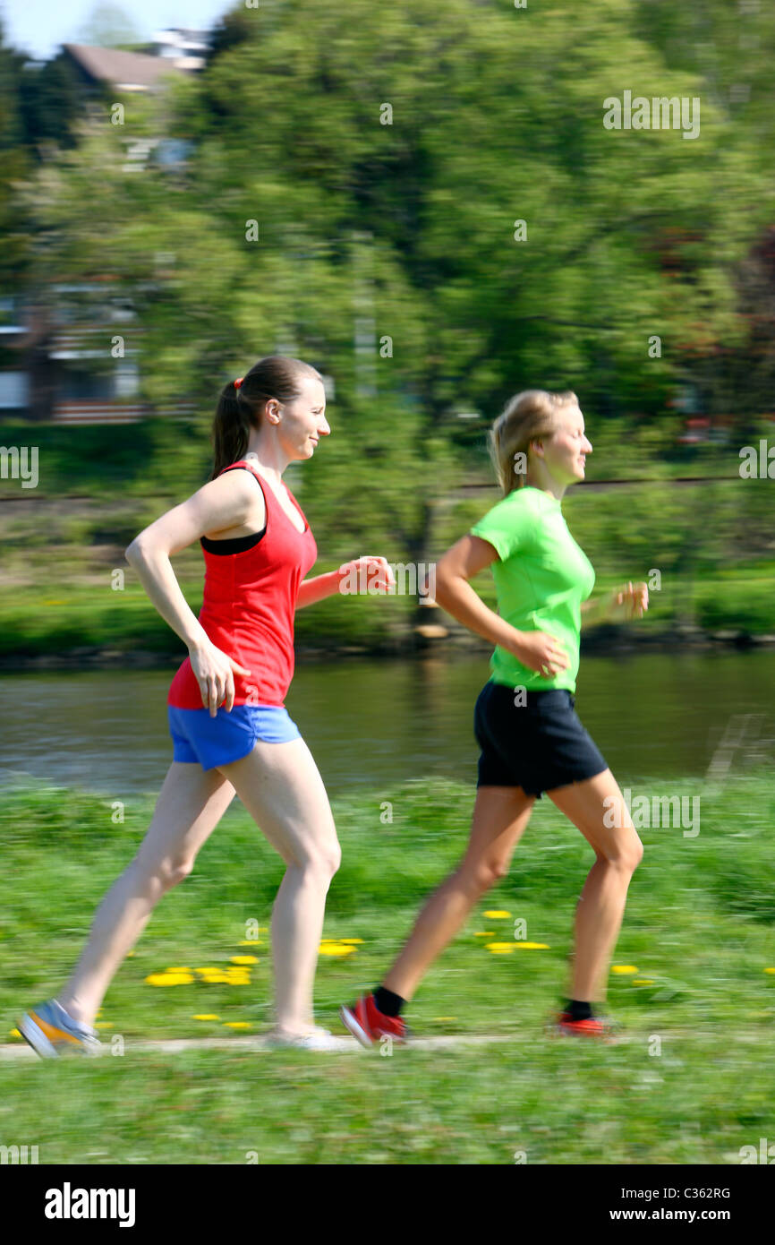 Two female hobby runners. Jogging in nature, in summer Stock Photo - Alamy