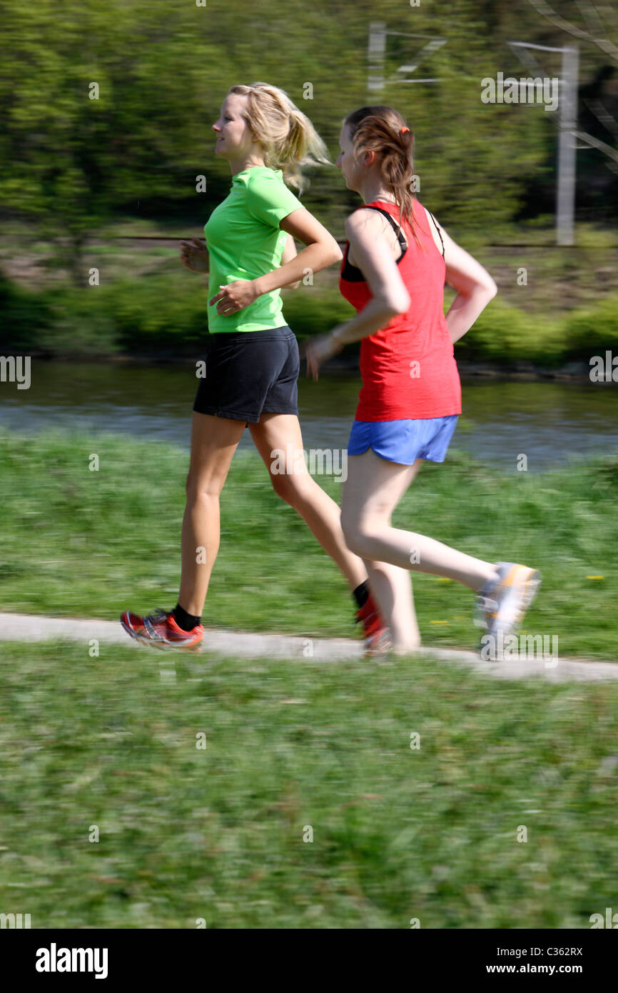Two female hobby runners. Jogging in nature, in summer Stock Photo - Alamy