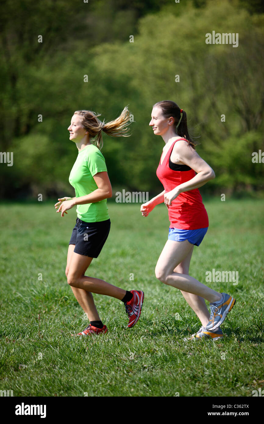 Two female hobby runners. Jogging in nature, in summer Stock Photo - Alamy