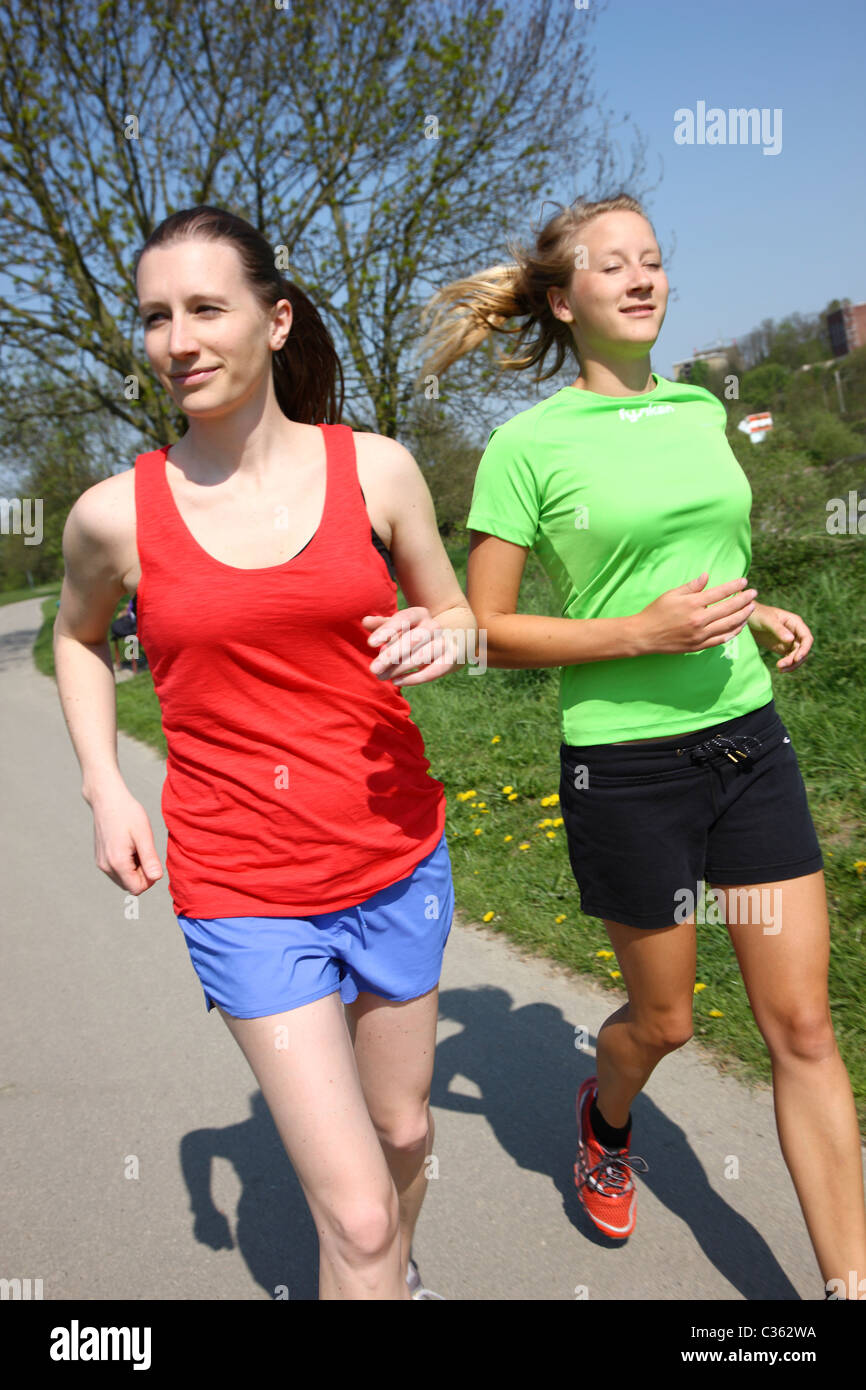 Two female hobby runners. Jogging in nature, in summer Stock Photo - Alamy