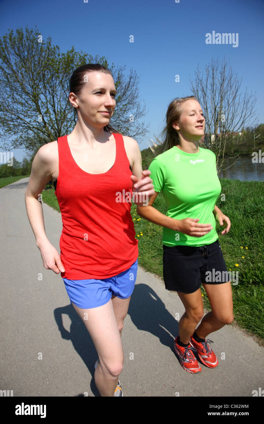 Two female hobby runners. Jogging in nature, in summer Stock Photo - Alamy