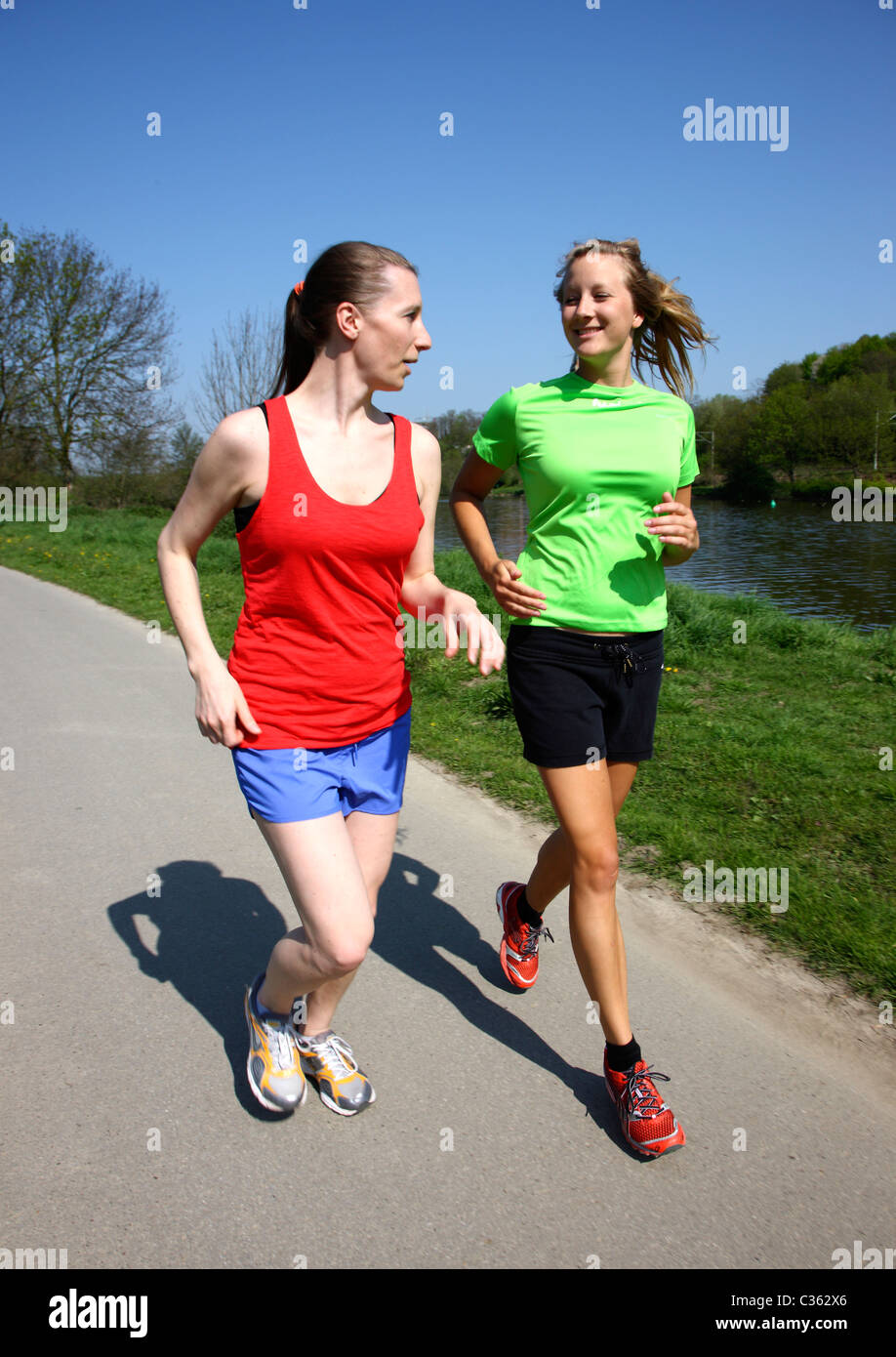 Two female hobby runners. Jogging in nature, in summer Stock Photo - Alamy