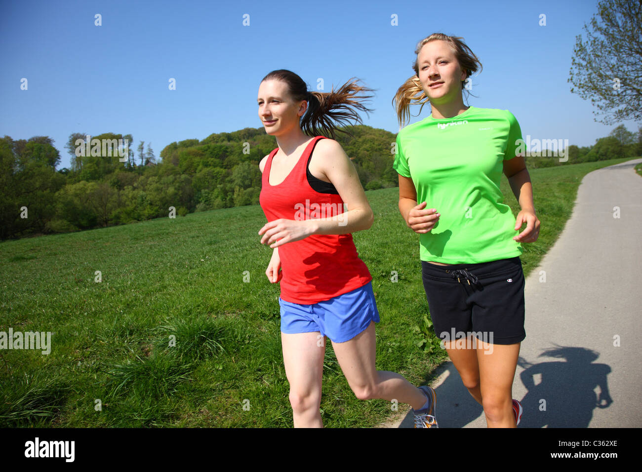 Two female hobby runners. Jogging in nature, in summer Stock Photo - Alamy