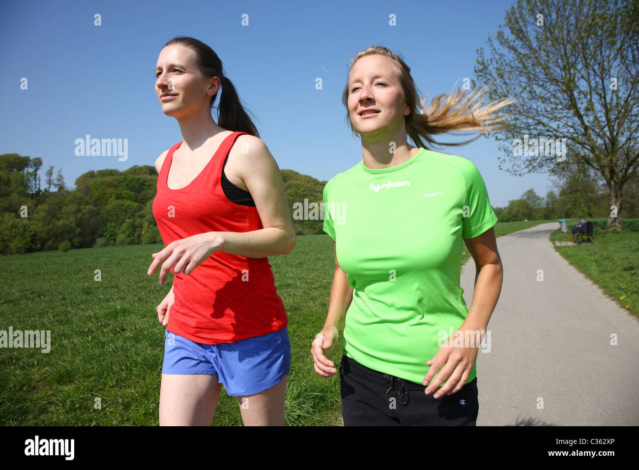 Two female hobby runners. Jogging in nature, in summer Stock Photo - Alamy