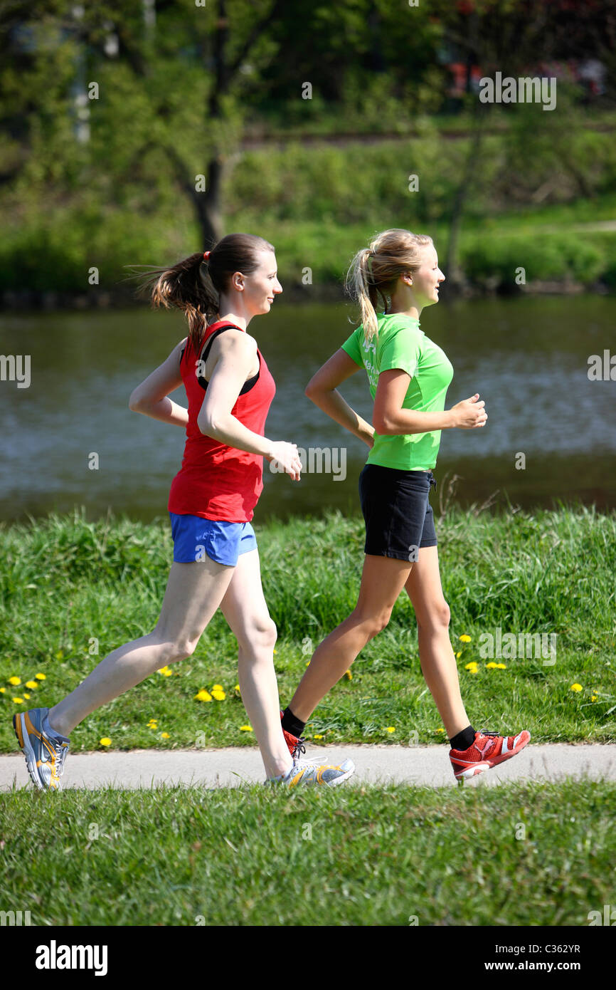 Two female hobby runners. Jogging in nature, in summer Stock Photo - Alamy