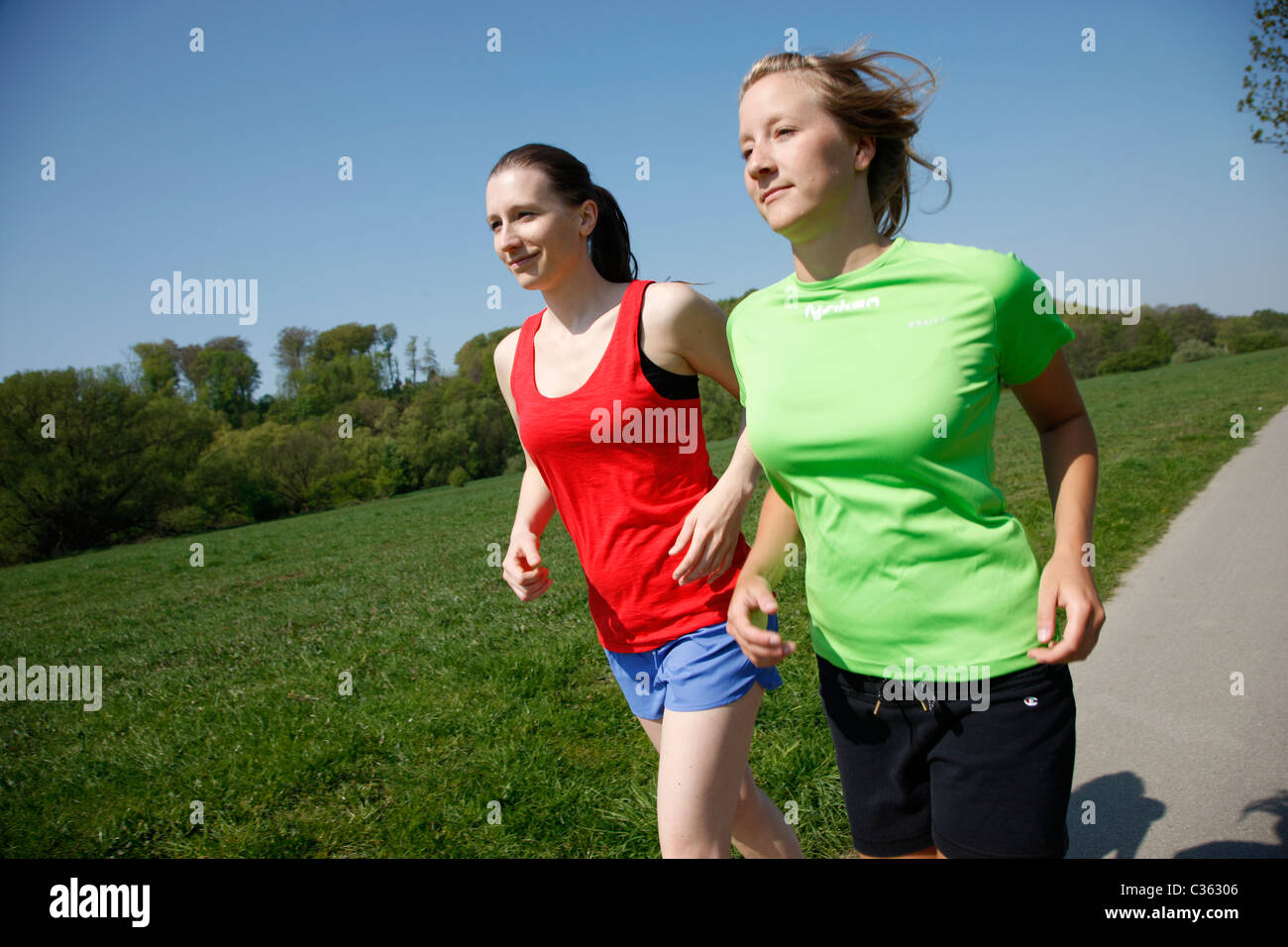 Two female hobby runners. Jogging in nature, in summer Stock Photo - Alamy