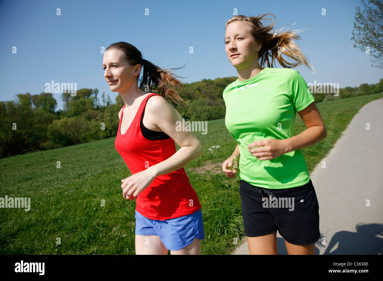 Two female hobby runners. Jogging in nature, in summer Stock Photo - Alamy