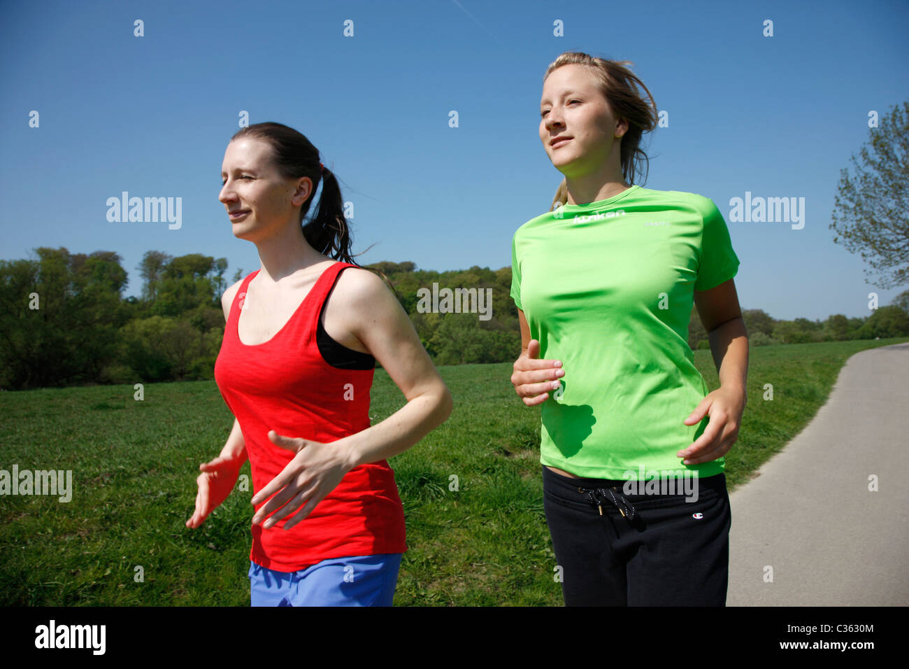 Two female hobby runners. Jogging in nature, in summer Stock Photo - Alamy