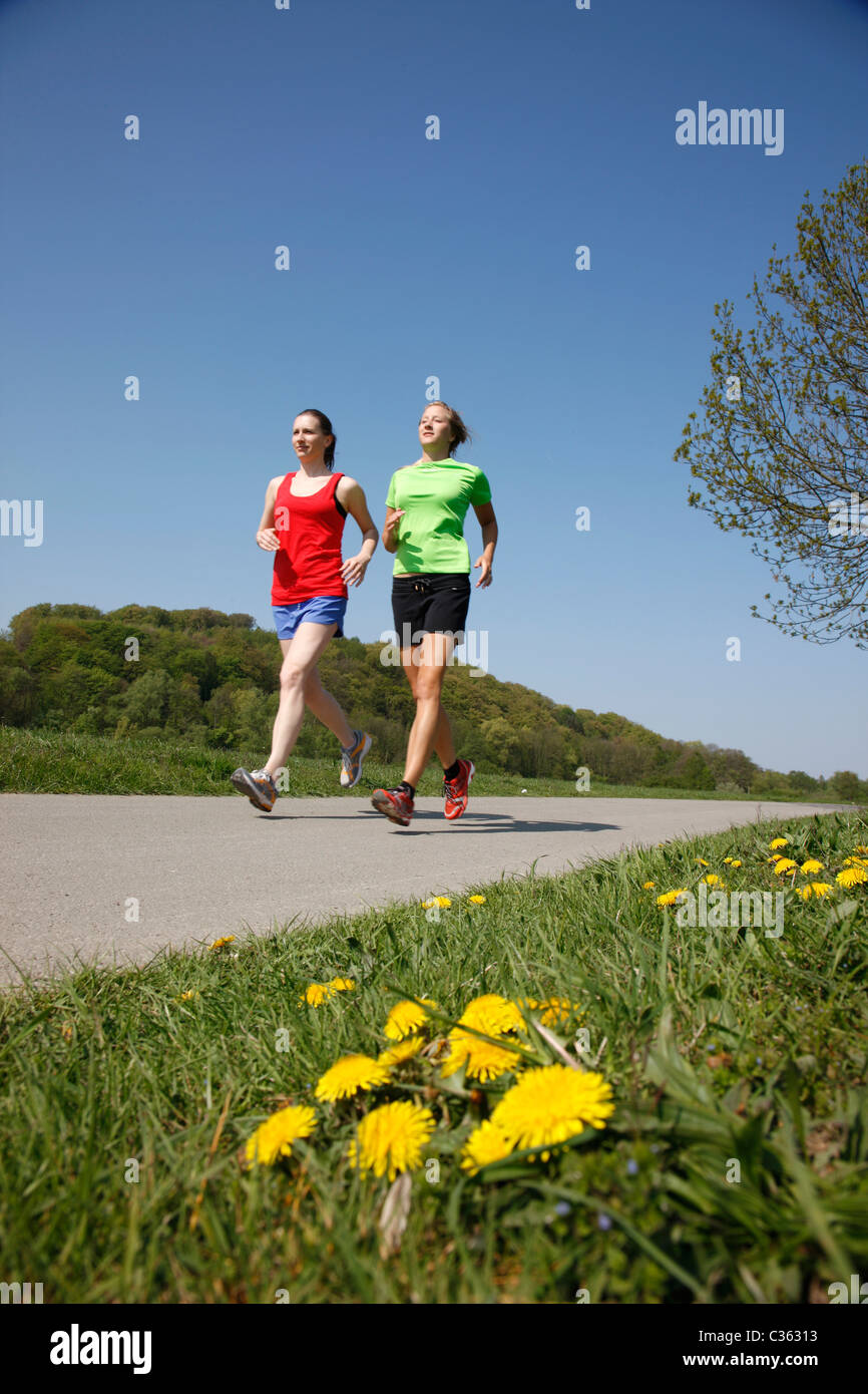 Two female hobby runners. Jogging in nature, in summer Stock Photo - Alamy