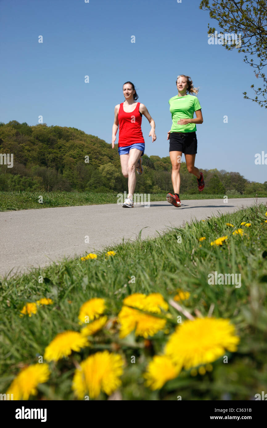 Two female hobby runners. Jogging in nature, in summer Stock Photo - Alamy