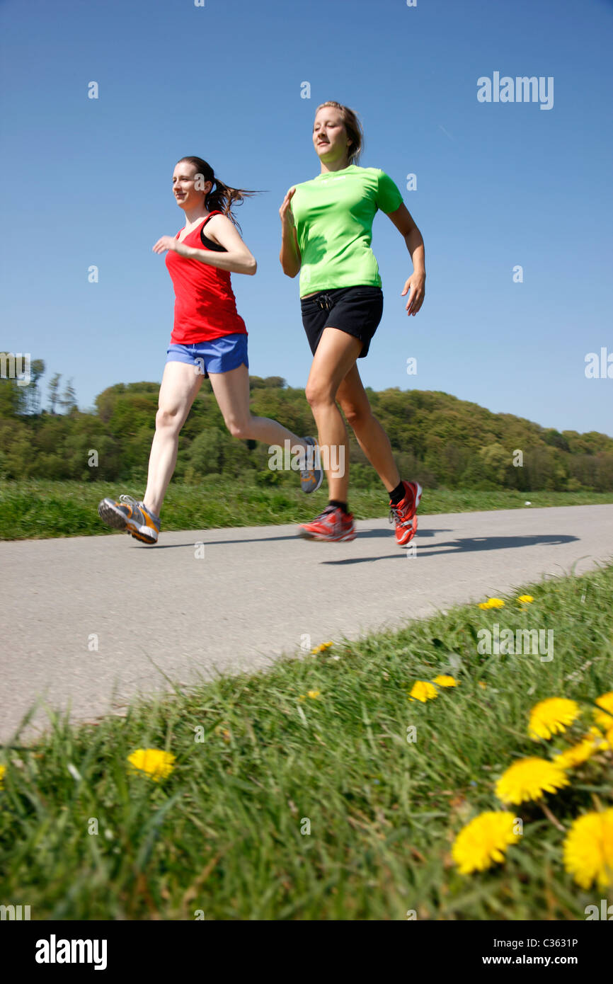 Two female hobby runners. Jogging in nature, in summer Stock Photo - Alamy