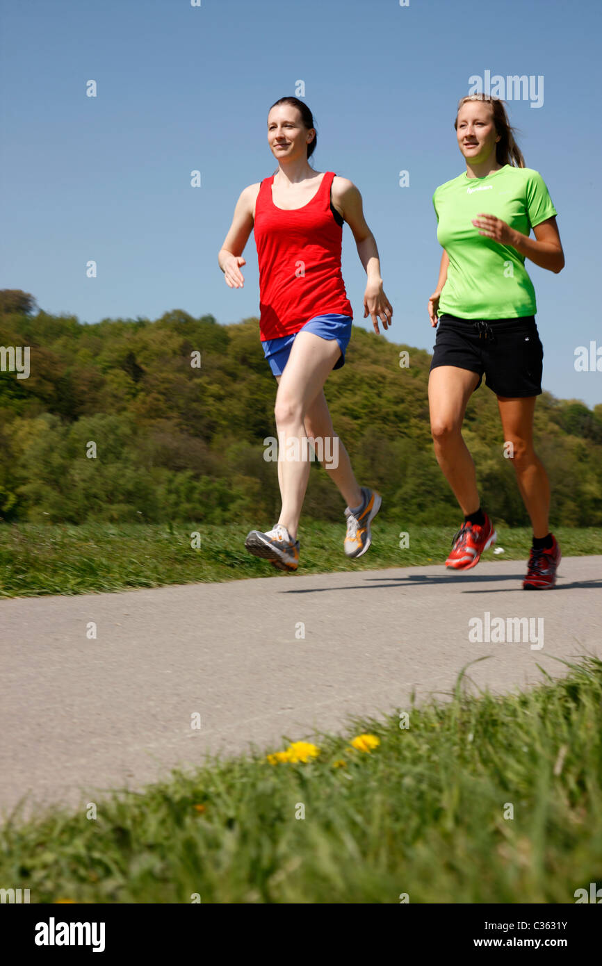 Two female hobby runners. Jogging in nature, in summer Stock Photo - Alamy