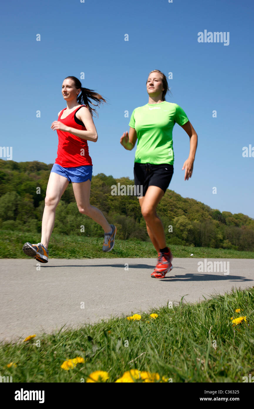 Two female hobby runners. Jogging in nature, in summer Stock Photo - Alamy