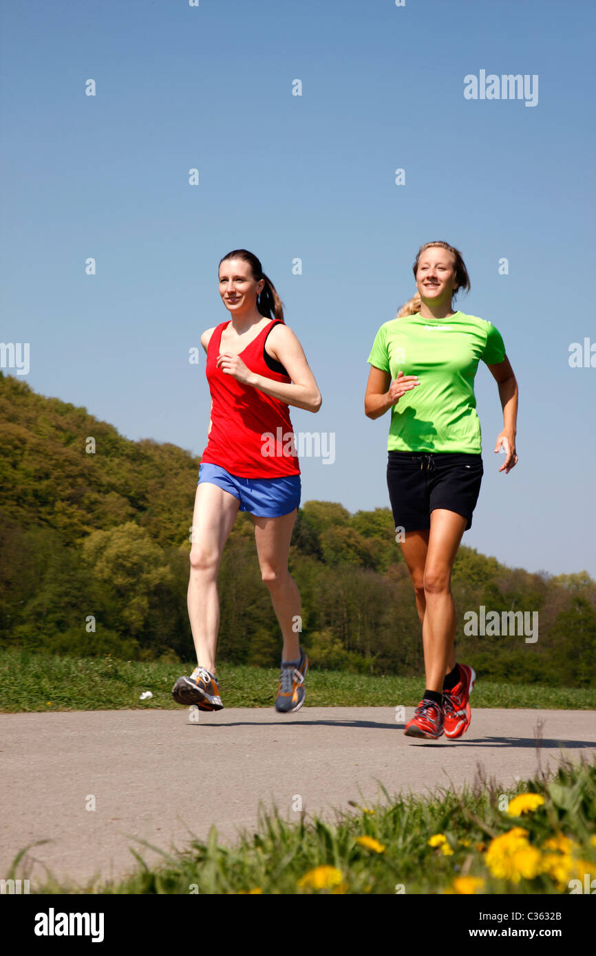 Two female hobby runners. Jogging in nature, in summer Stock Photo - Alamy